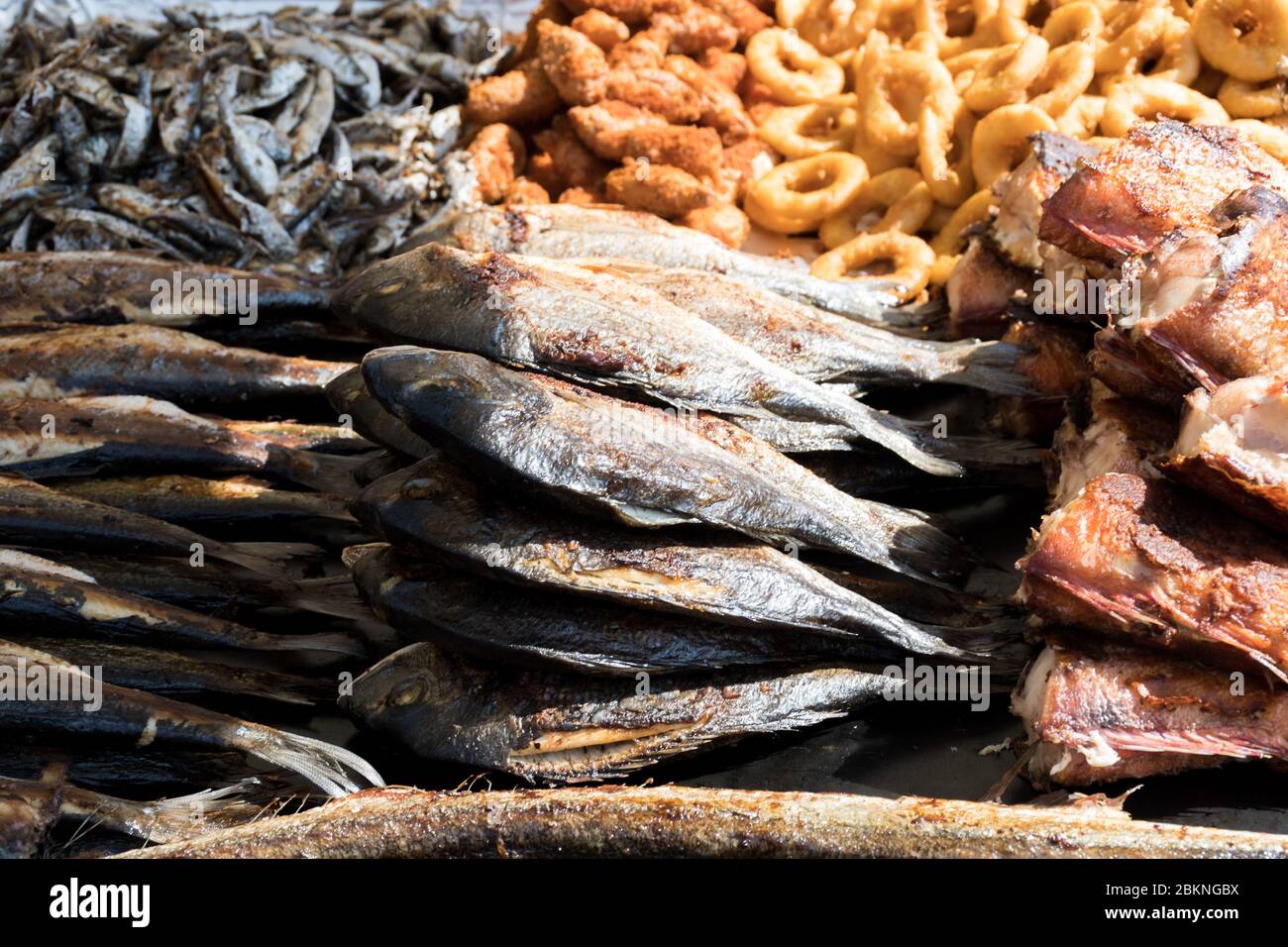 Freshly grilled fish on counter top stall, during seafood festival ...