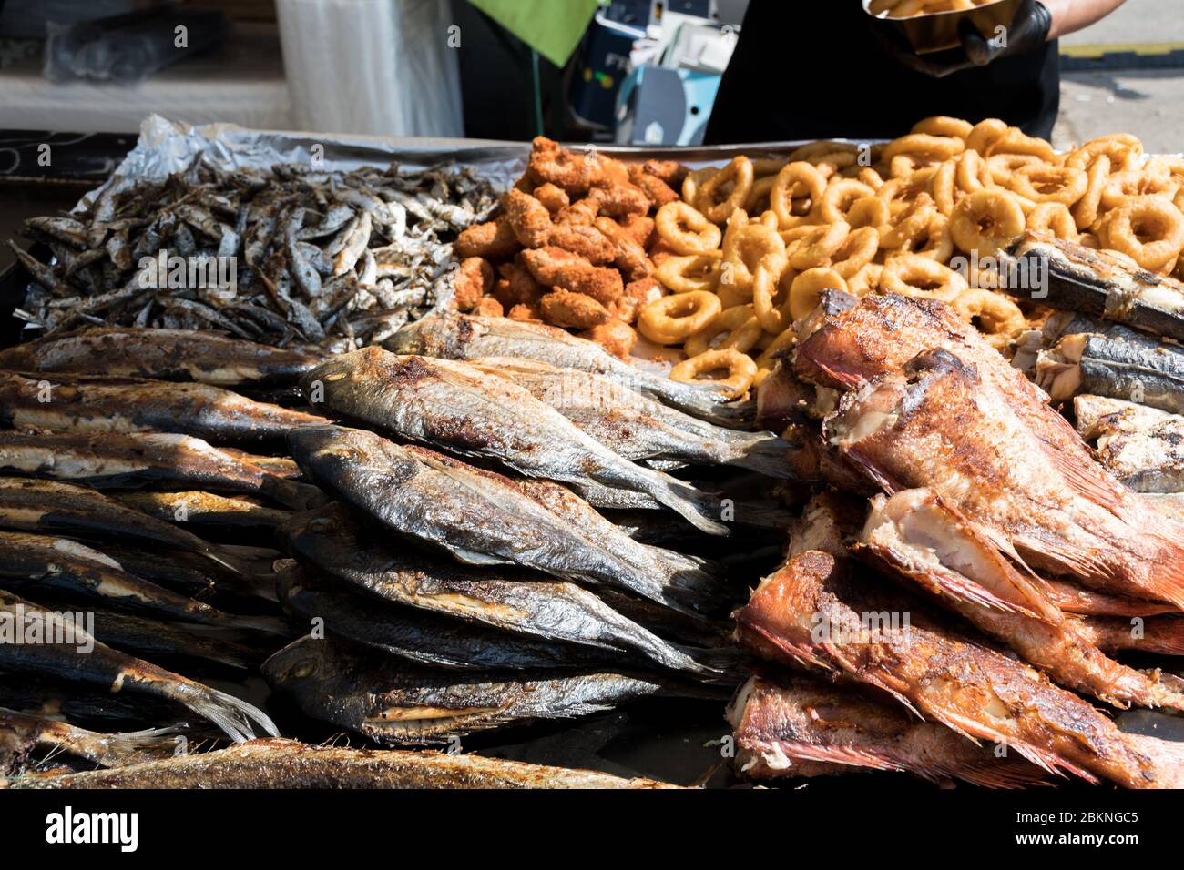 Freshly grilled fish on counter top stall, during seafood festival ...