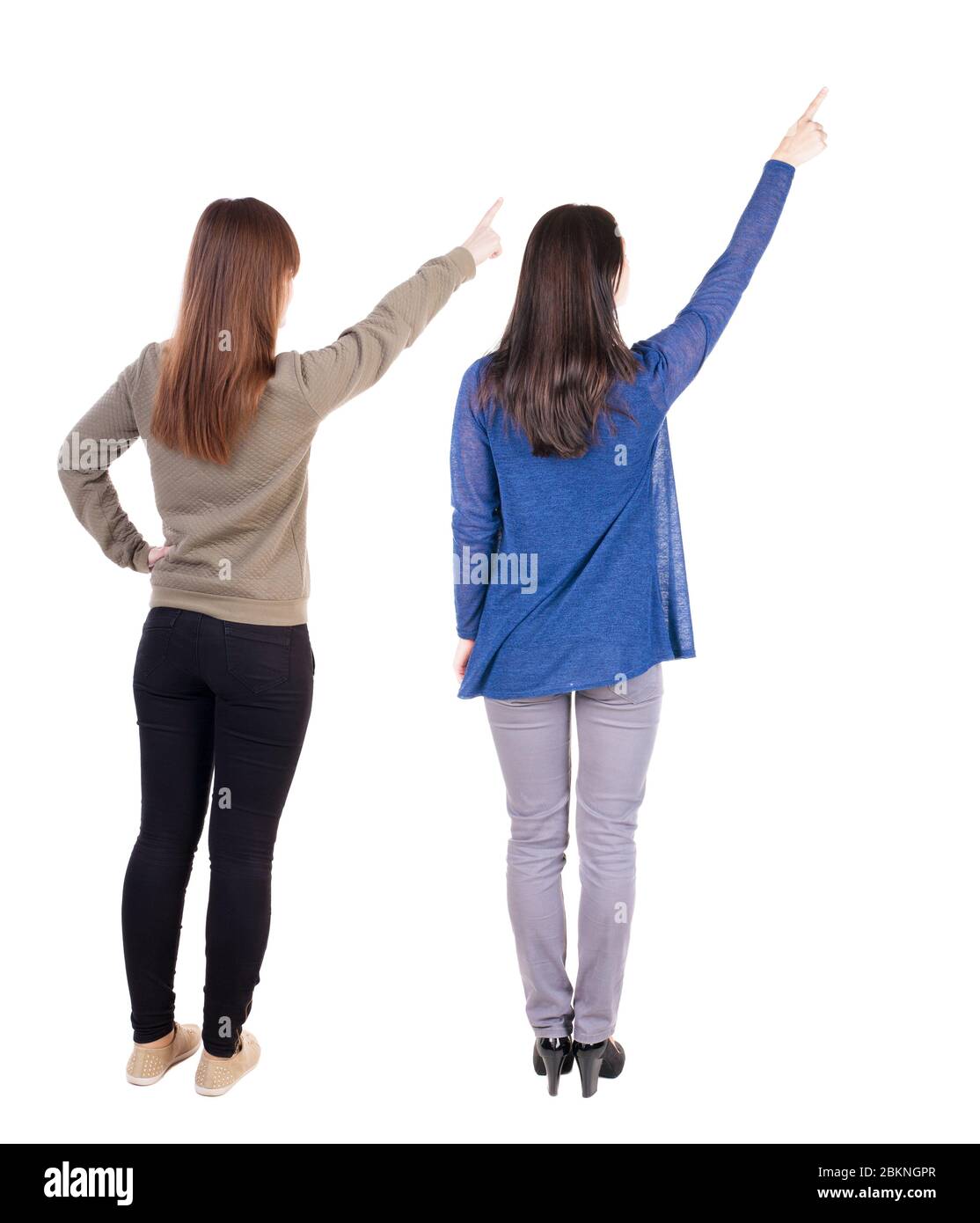 Back view of two pointing girl in sweater. Rear view people collection ...