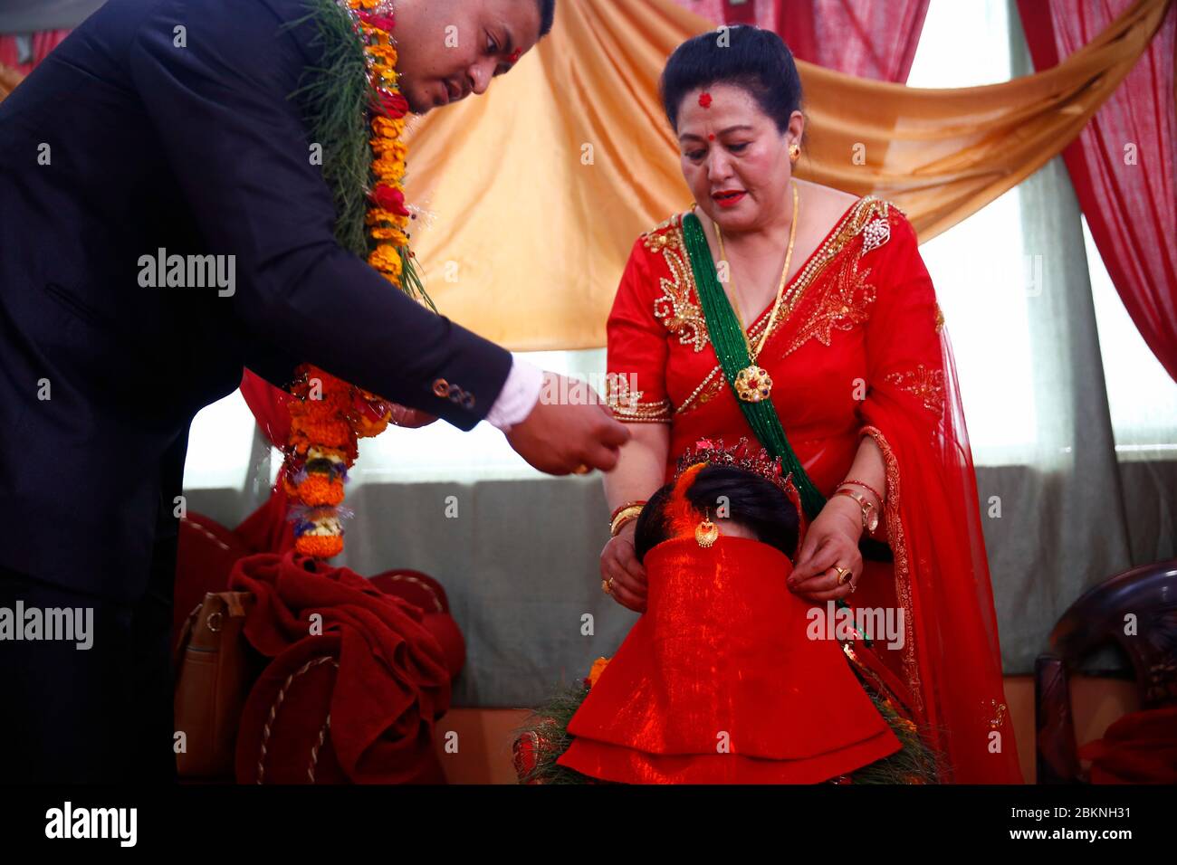 Kathmandu, Nepal. 5th May, 2020. The groom Rabi Shrestha applies ...