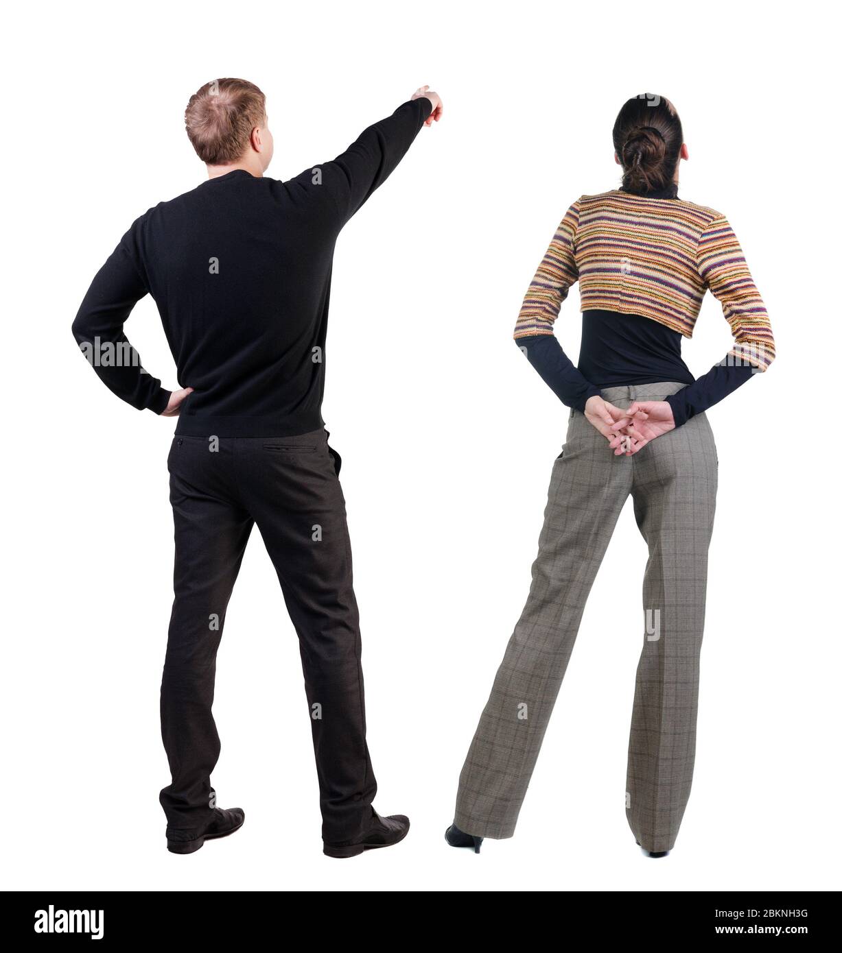 Back view of couple in sweater pointing. Rear view people collection ...