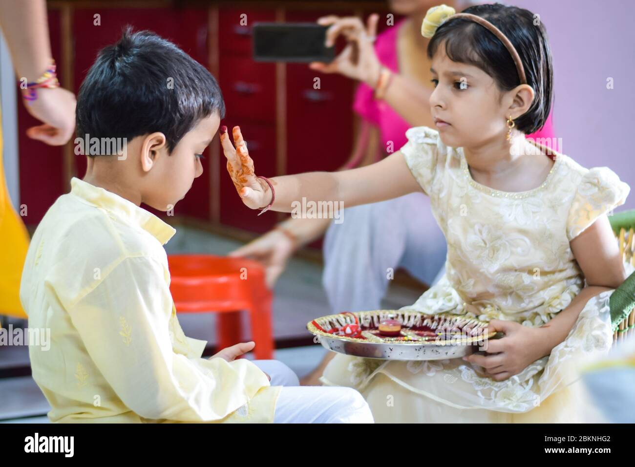 cute girl applying tika on her little brother's forehead Stock Photo ...