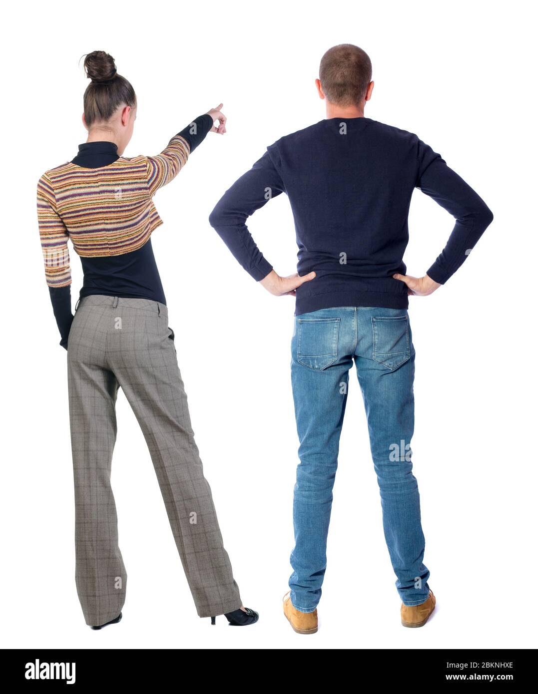 Back view of couple in sweater pointing. Rear view people collection ...