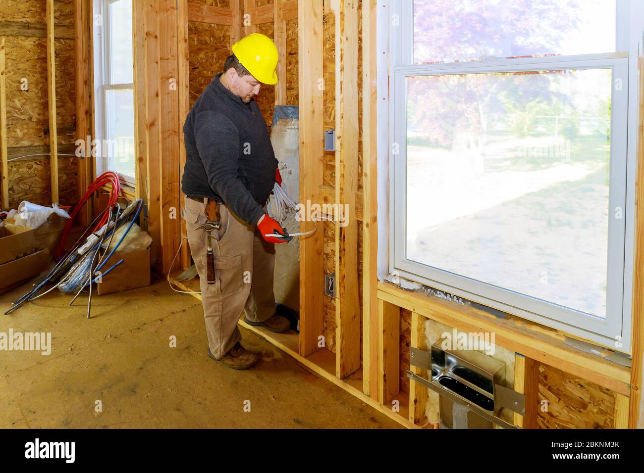 Working process on of electrical wires in walls new home construction ...