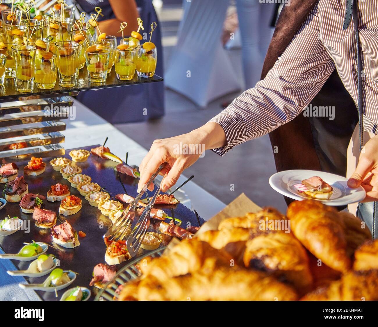 Female hands taking food at a banquet at a conference Stock Photo - Alamy