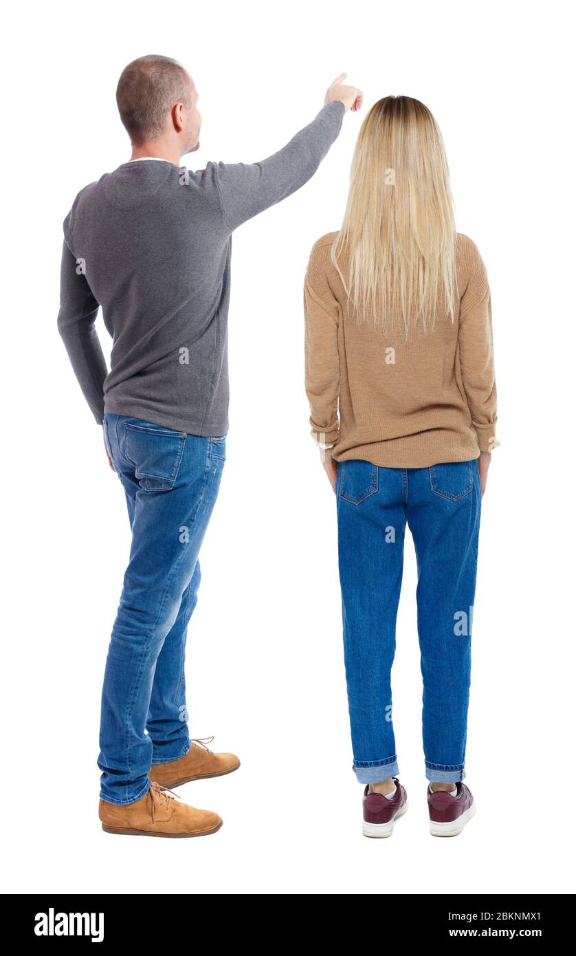 Back view of couple in sweater pointing. Rear view people collection ...