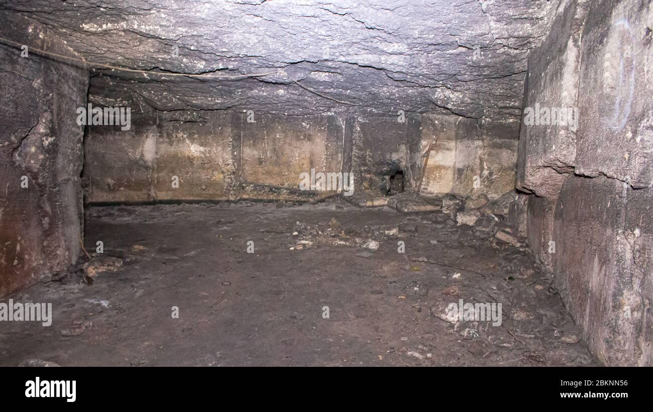 Old underground passage, dungeon, catacombs lined with stones ...