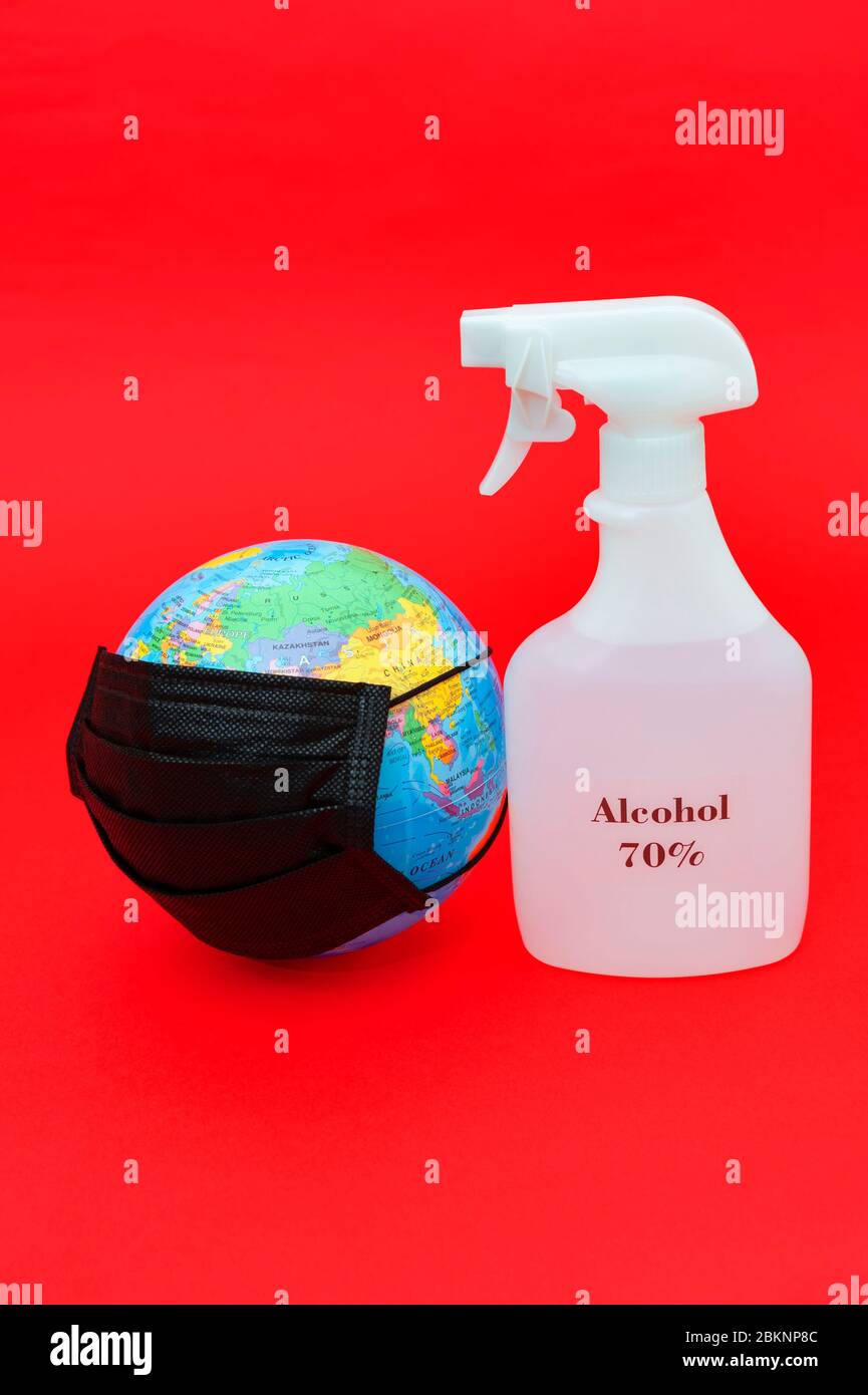 Earth globe model with black surgical mask and 70% alcohol isolated on ...