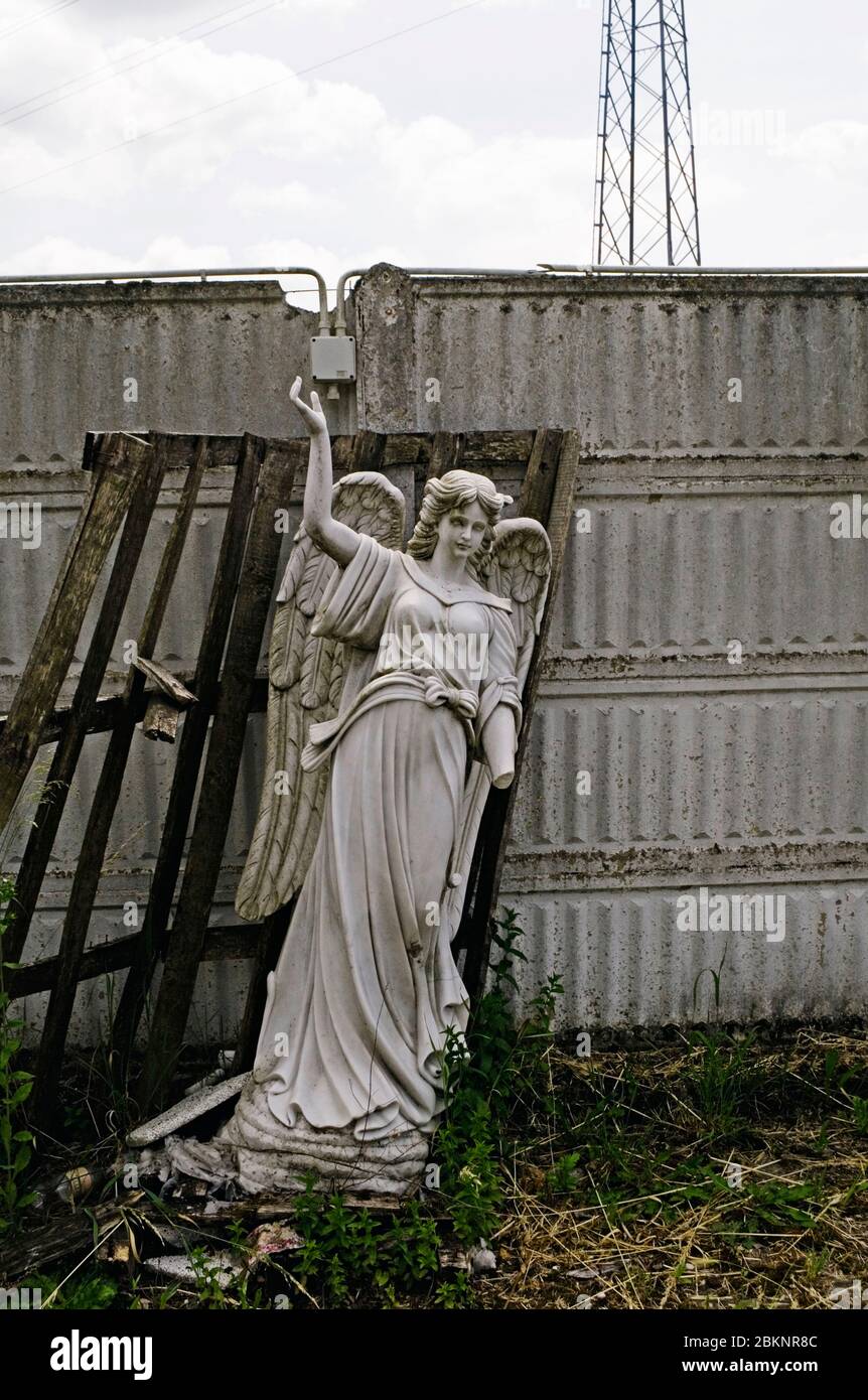 abandoned angel statue against the wall Stock Photo - Alamy