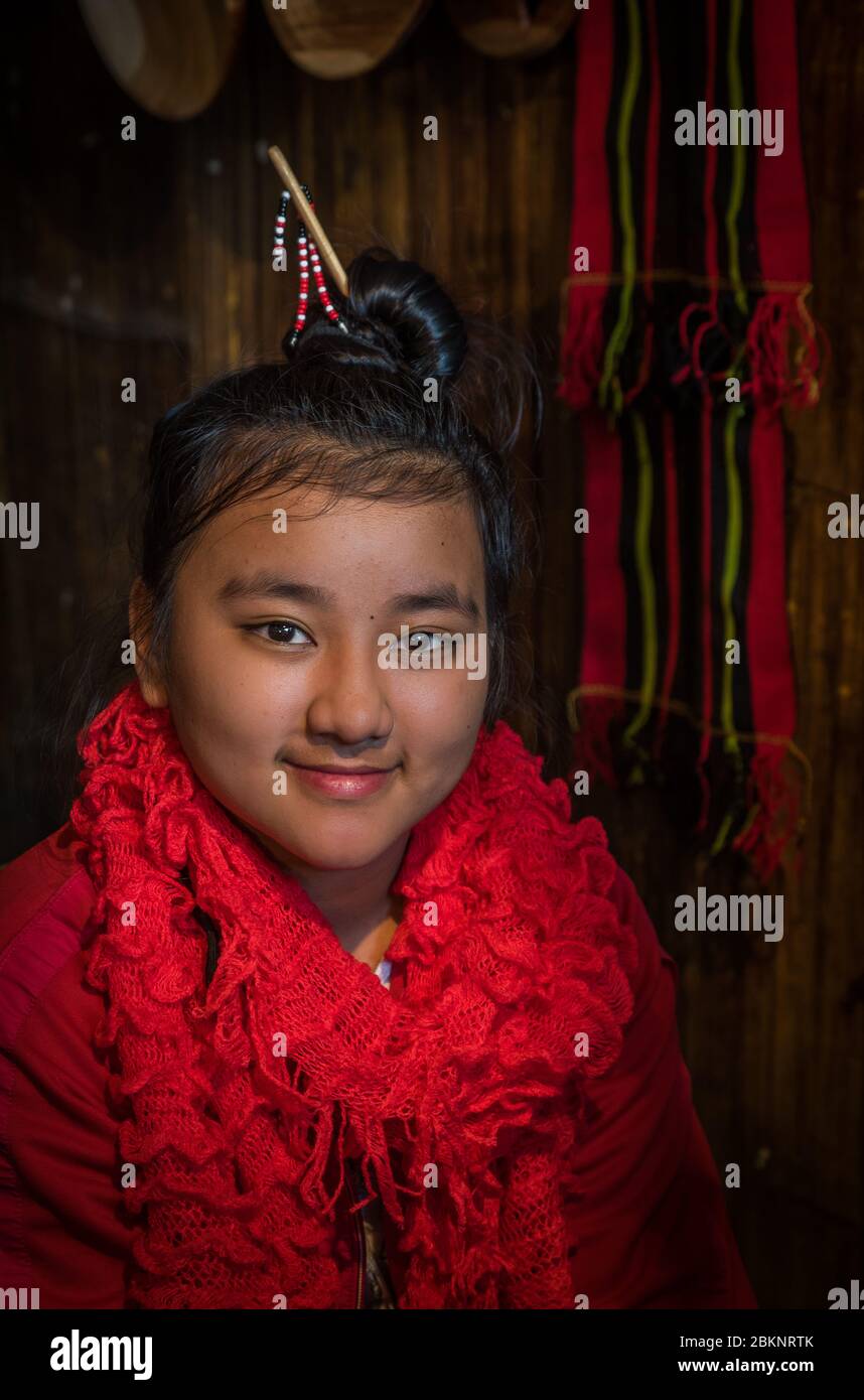 Close-up portrait of brightly dressed Indian girl. A trader at the ...