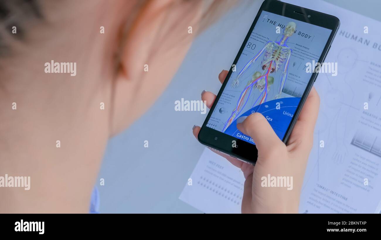 MOSCOW, RUSSIA - AUGUST 1, 2019. Woman using smartphone with augmented ...