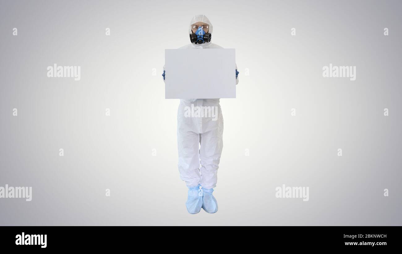 Lab scientist in safety suit holding empty white board on gradient ...