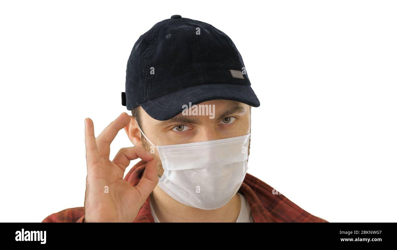 Caucasian man wearing a protection mask making ok sign on white ...
