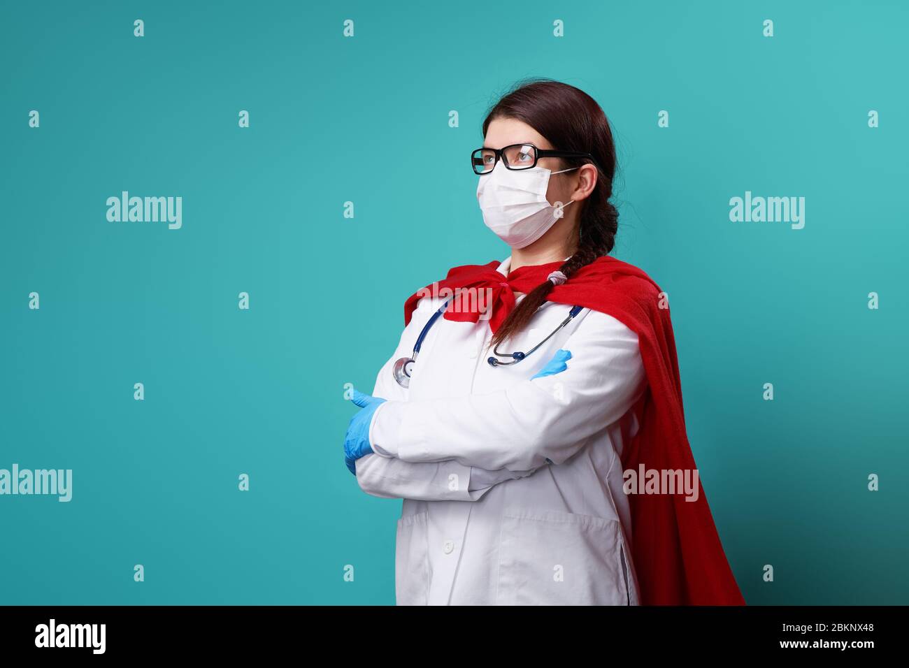 Doctor wearing surgical face mask in superhero cape. Concept of super ...