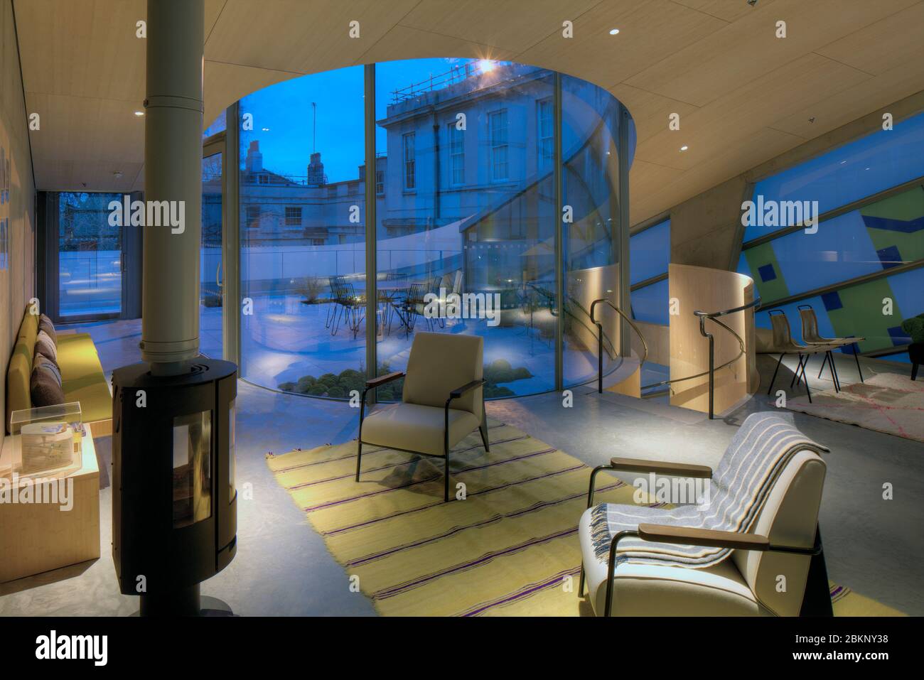 Top floor seating area, roof terrace beyond with curved glass screen ...