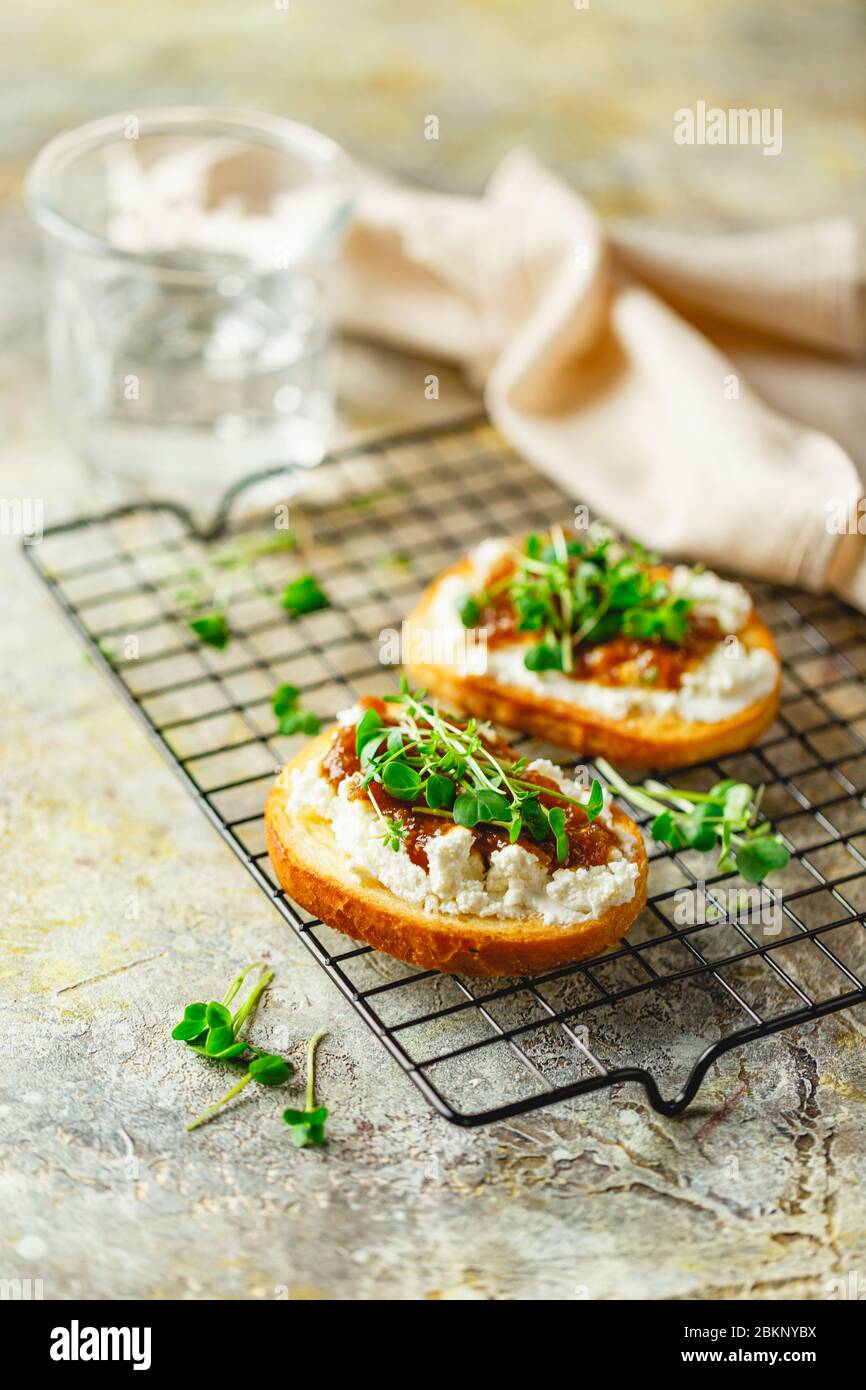Canape or crostini with toasted baguette, cottage cheese, fig jam and ...