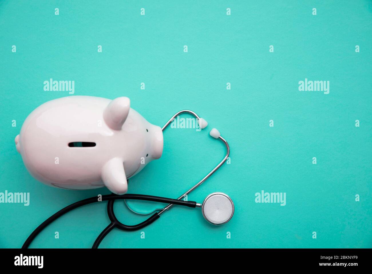 Cost of healthcare. Piggy bank money box with a medical doctors ...