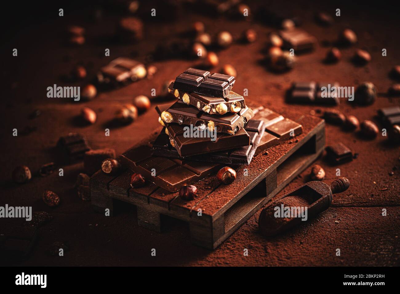 Hazelnut black chocolate bar tower on dark wooden background Stock ...