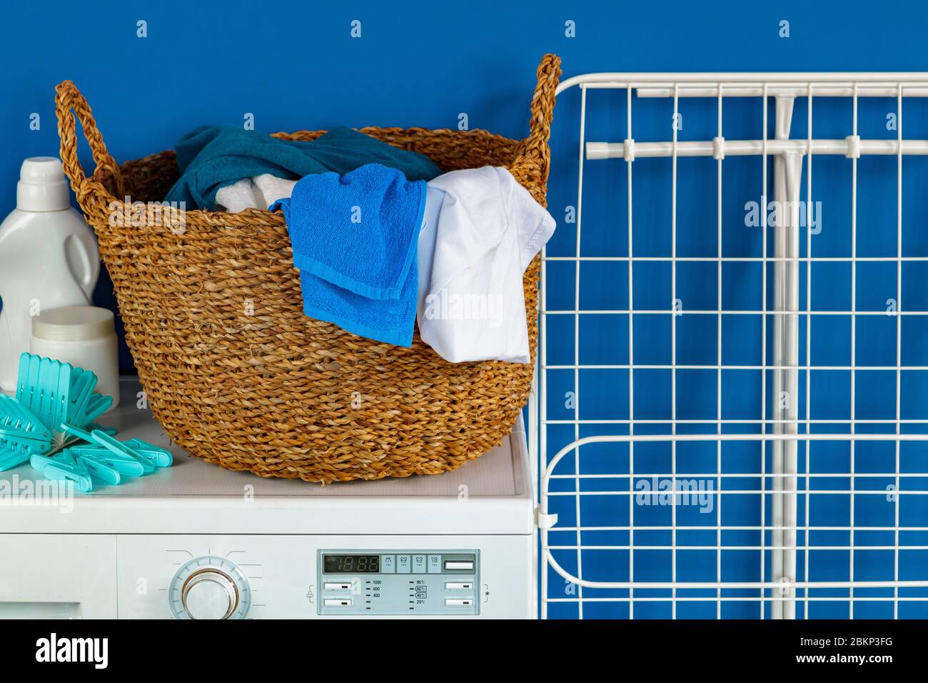 Laundry room interior with washing machine and clothes dryer near wall ...