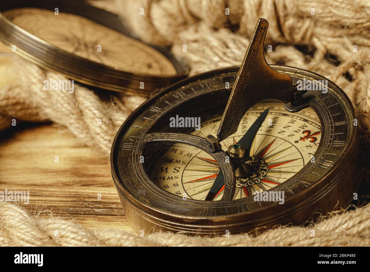 Ship rope and compass on wooden background Stock Photo - Alamy