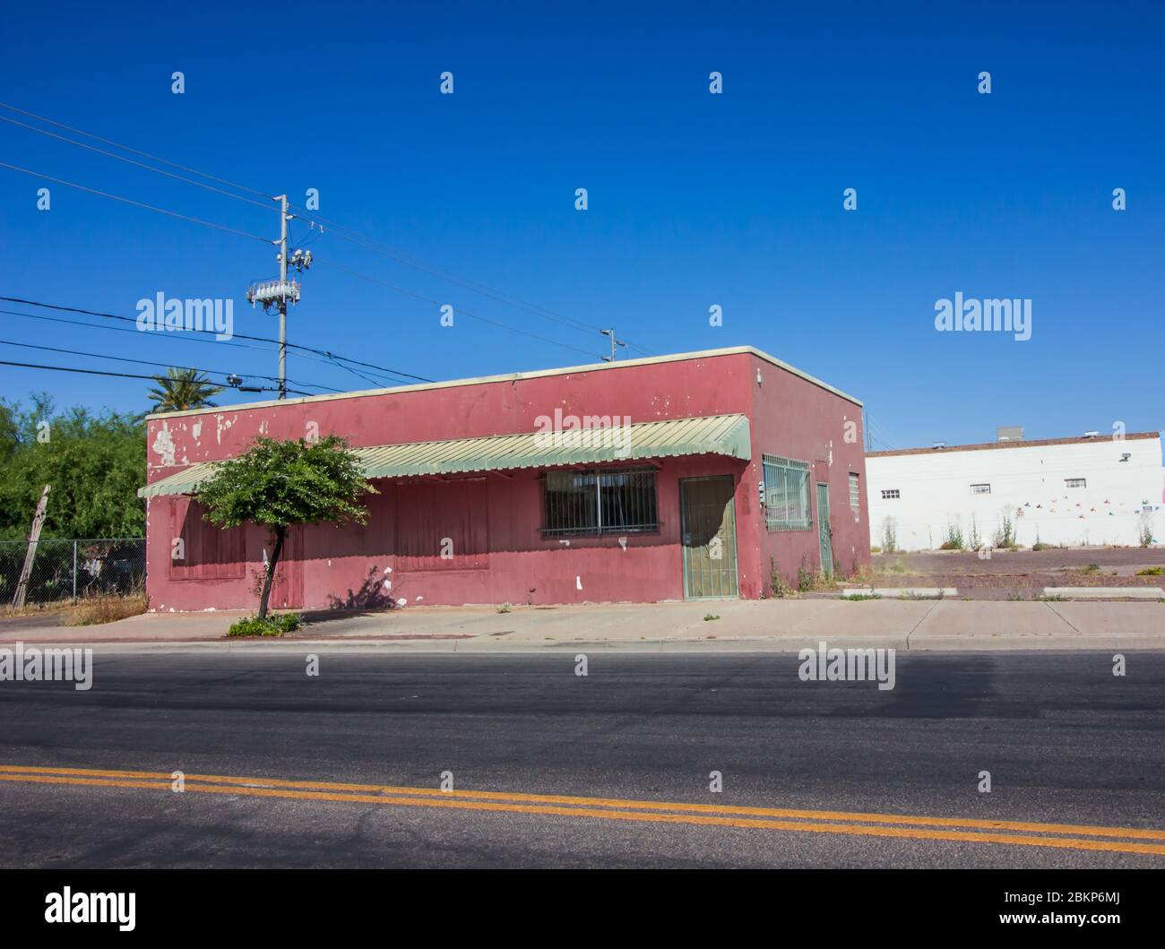 Old Coral Colored Building With Bars On Windows Stock Photo - Alamy