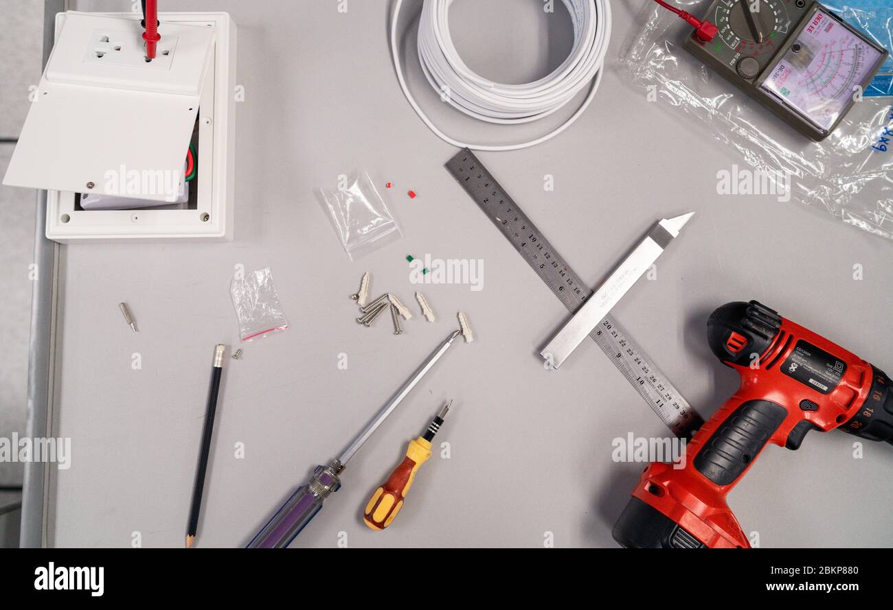 Top view work tools and electrical equipment on a desk Stock Photo - Alamy