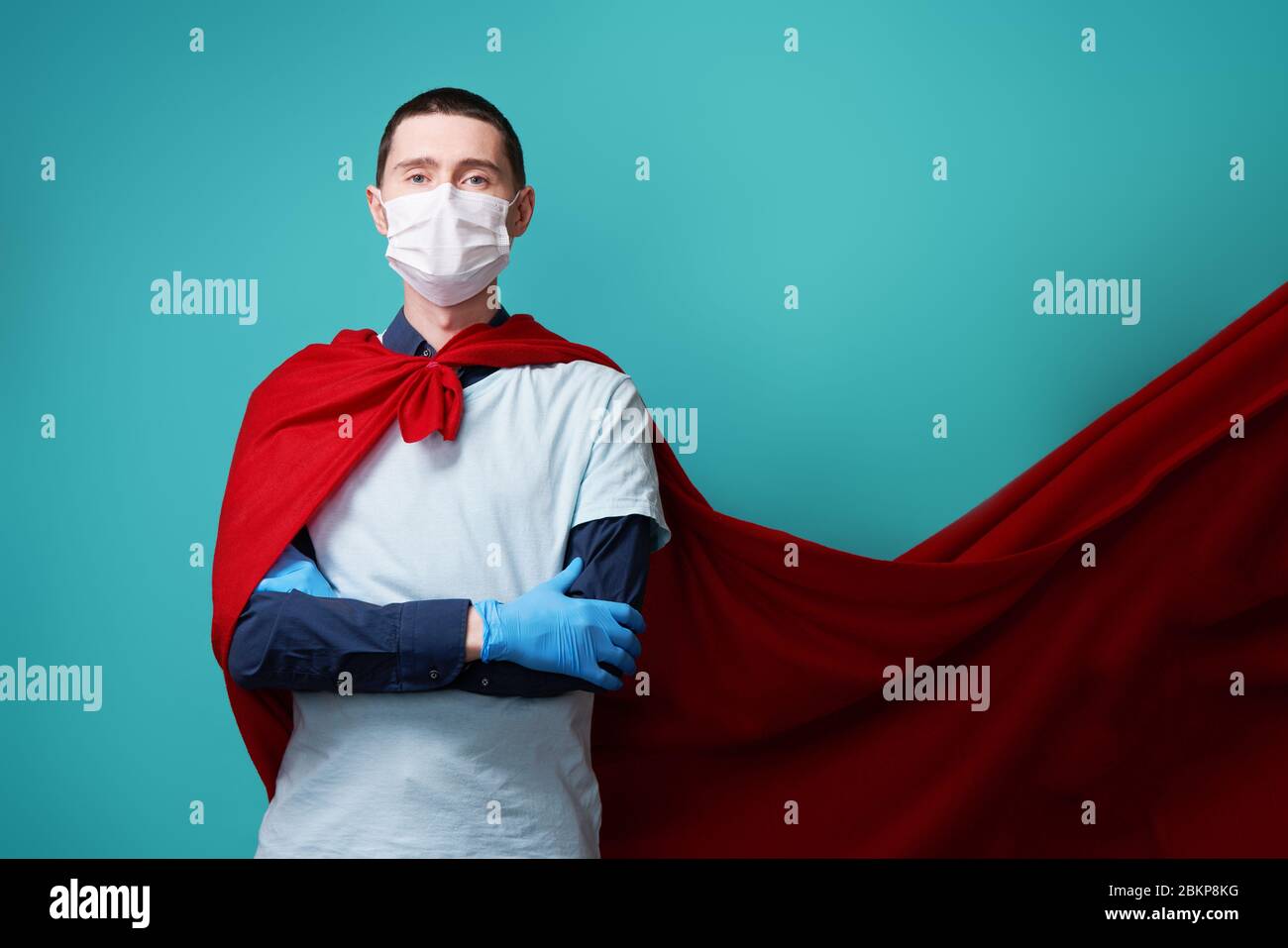 Volunteer is wearing surgical mask in superhero cloak. Concept of super ...