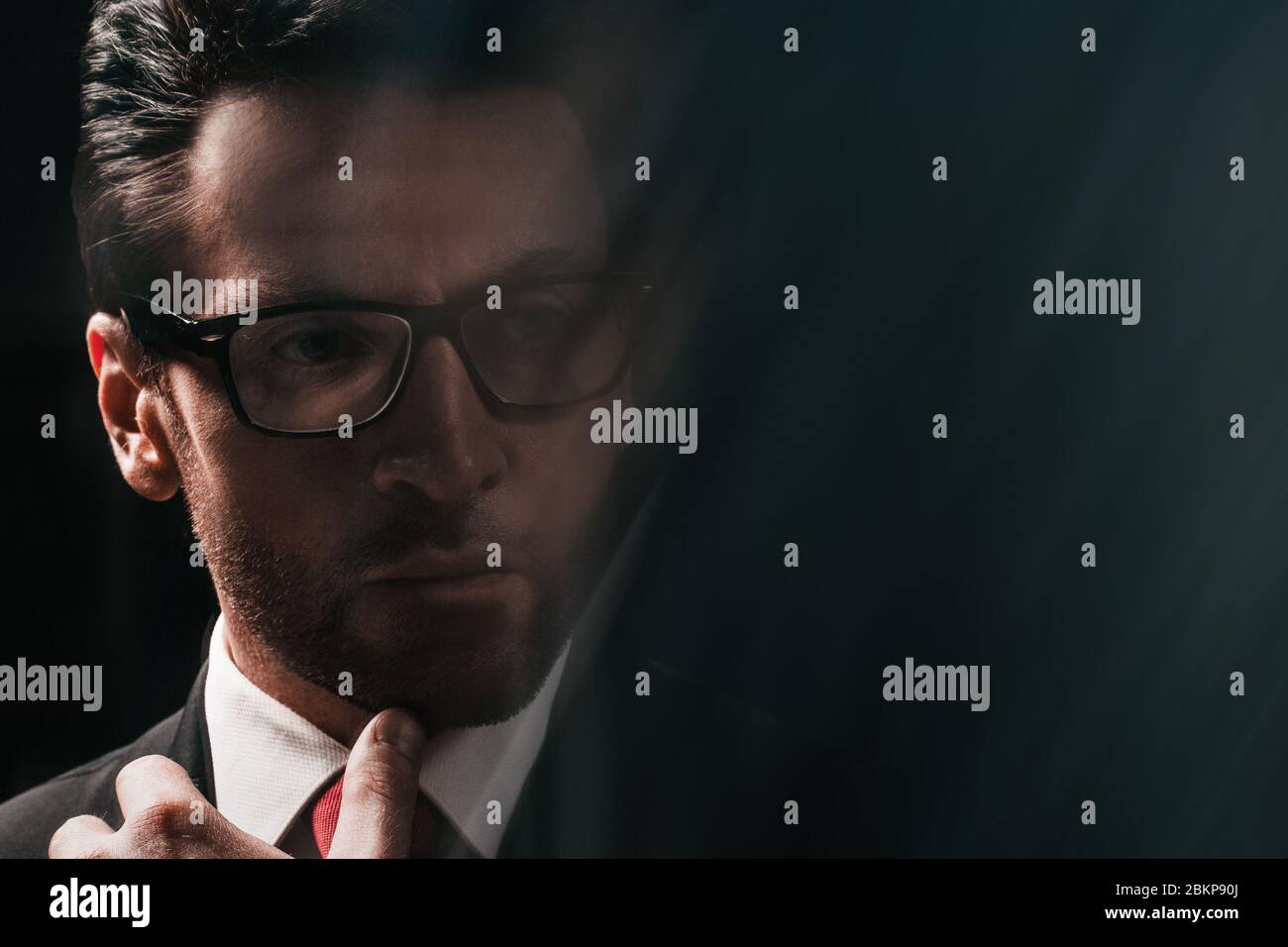close up.businessman standing in a dark office Stock Photo - Alamy
