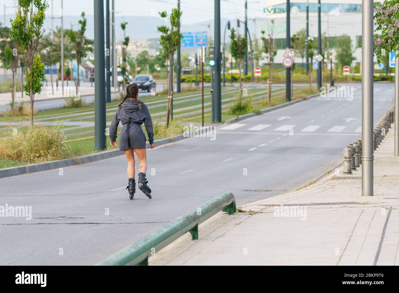 Young girl skating in the street at the end of the period of compulsory ...