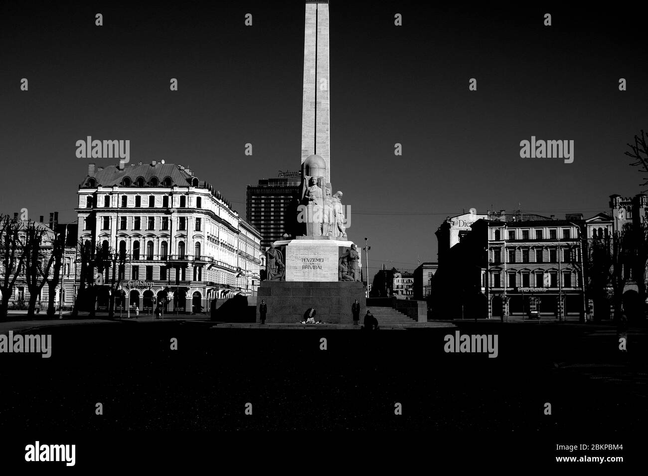 Monument of freedom in Riga. Woman holding three gold stars which ...