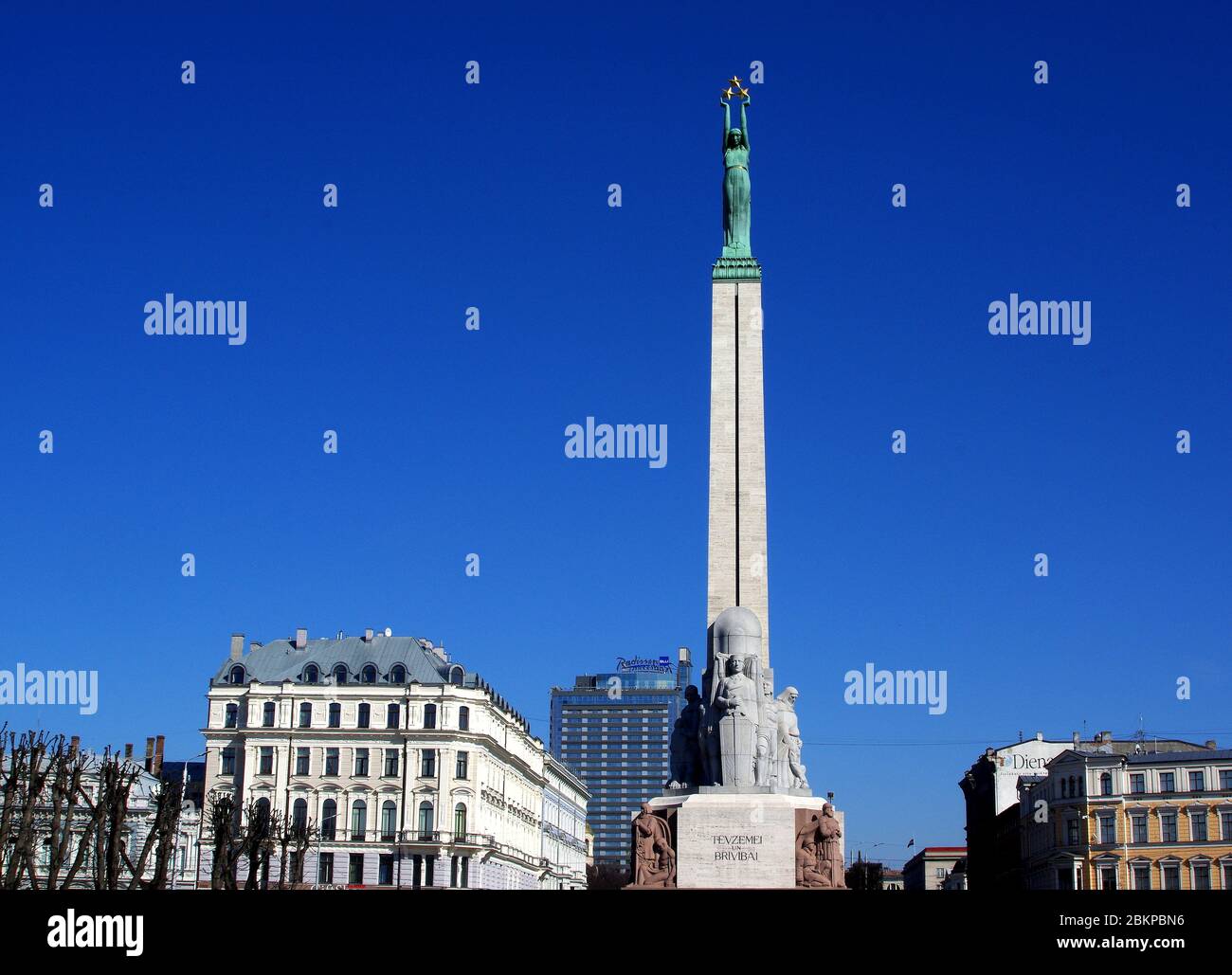 Monument of freedom in Riga. Woman holding three gold stars which ...