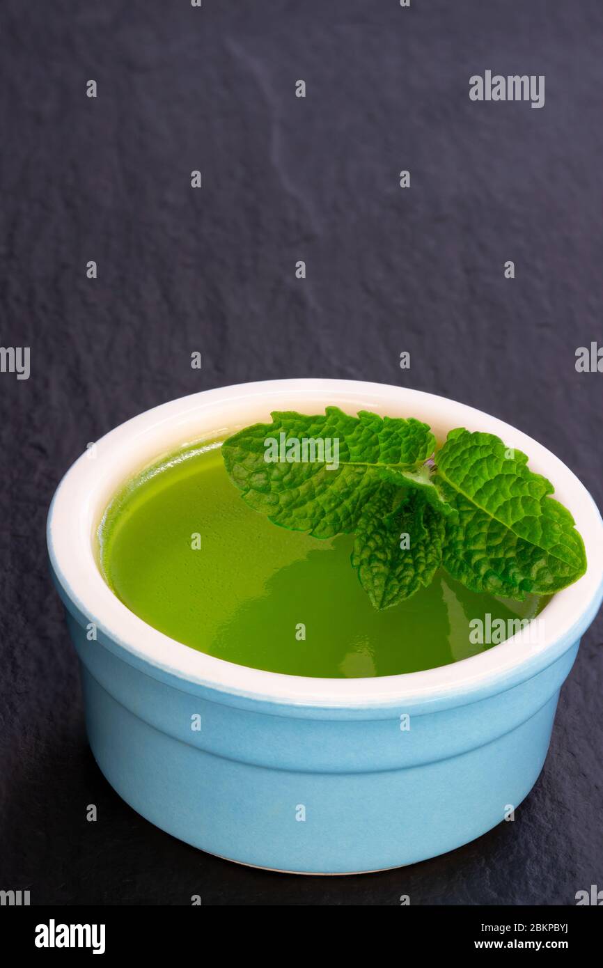Mint jelly in small pot on black stone background Stock Photo - Alamy