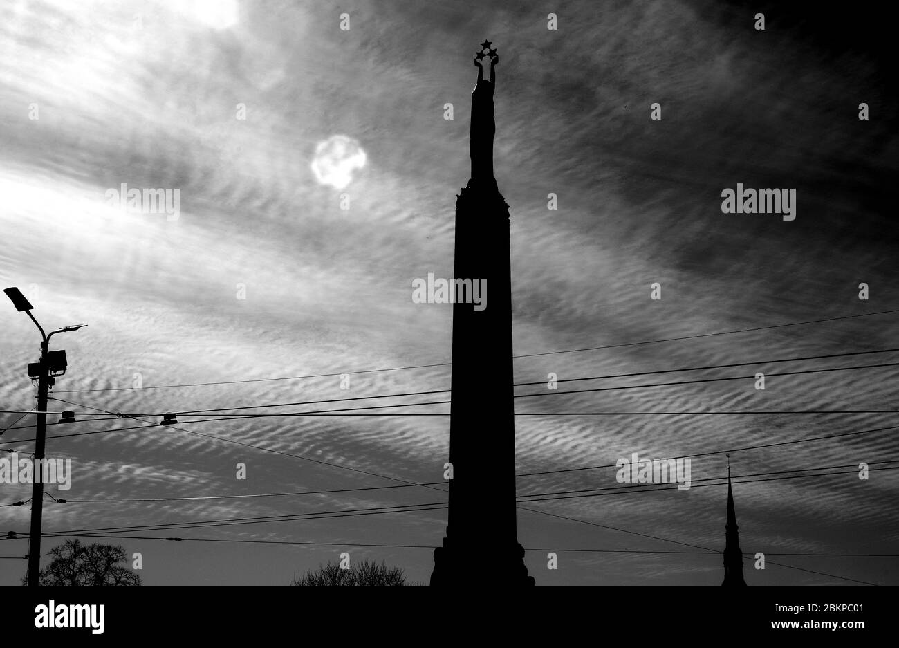 Monument of freedom in Riga. Woman holding three gold stars which ...