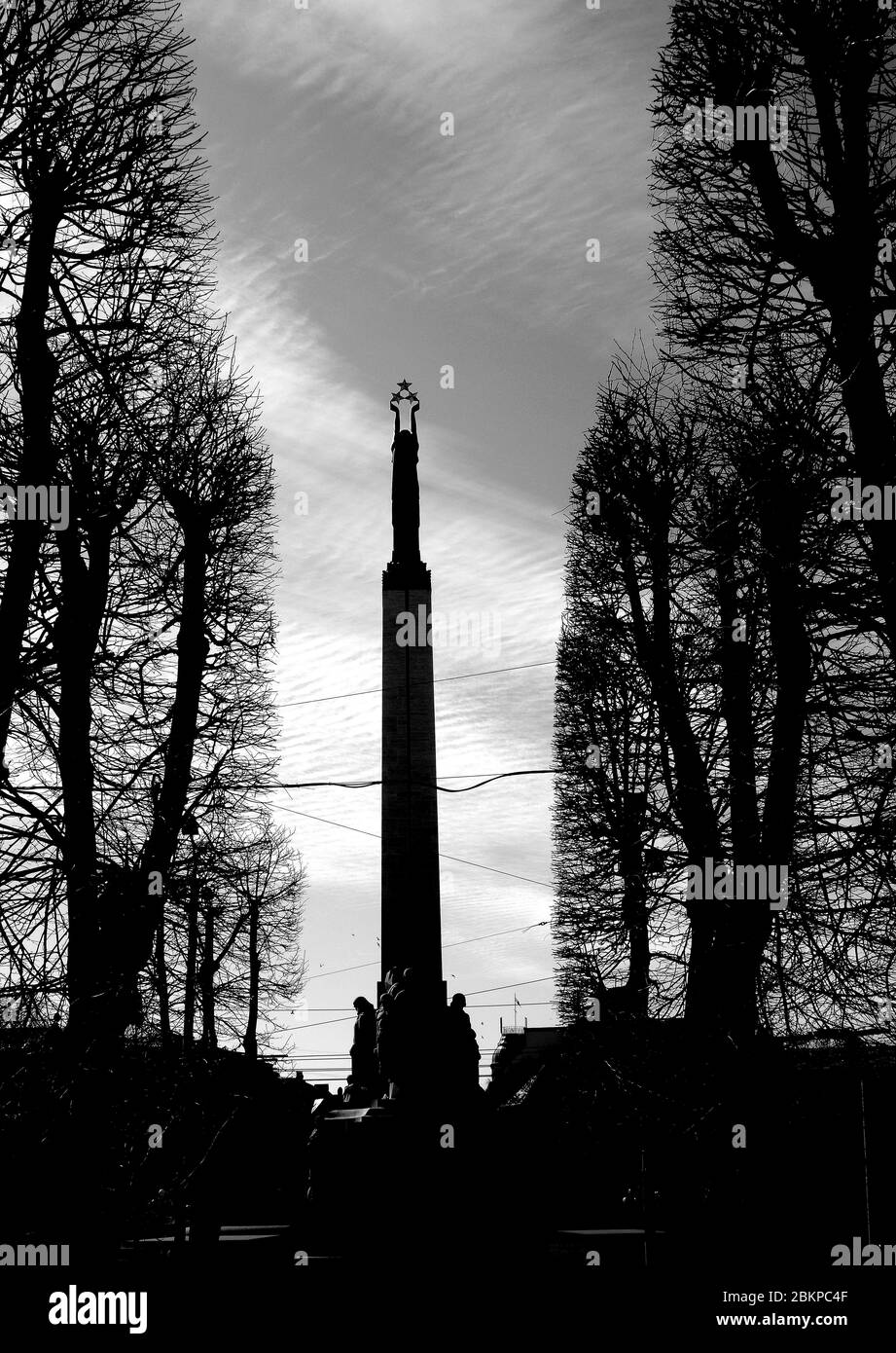Monument of freedom in Riga. Woman holding three gold stars which ...