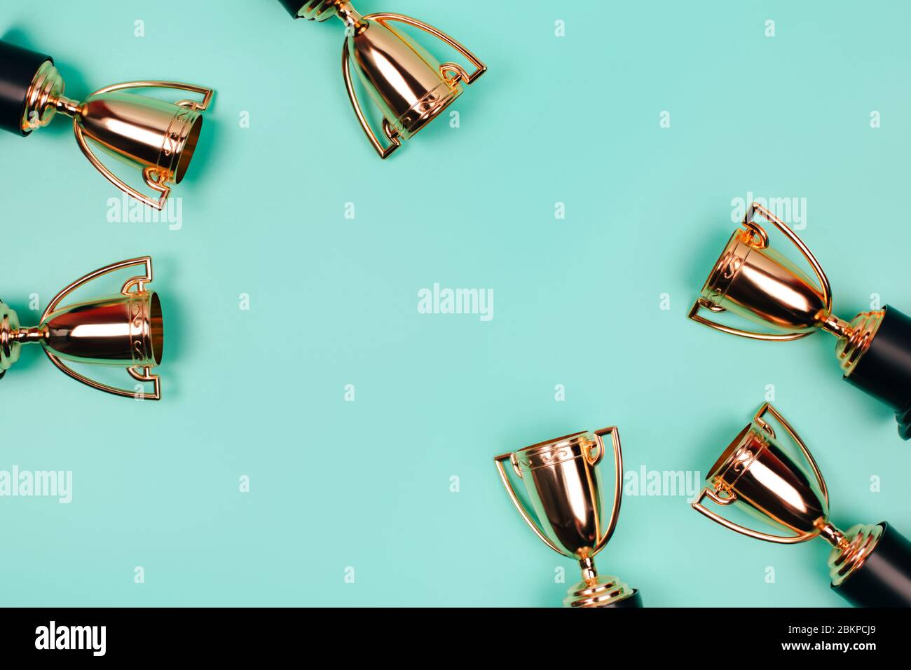 Frame made of winner cups on a pastel blue background with copy space ...