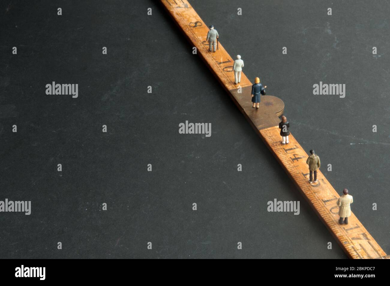 Social distancing coronavirus queue of miniature people walking on a ...