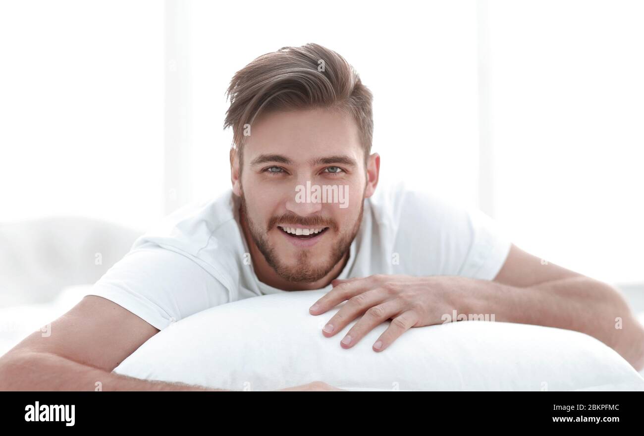 closeup.smiling man lying on the sofa Stock Photo - Alamy