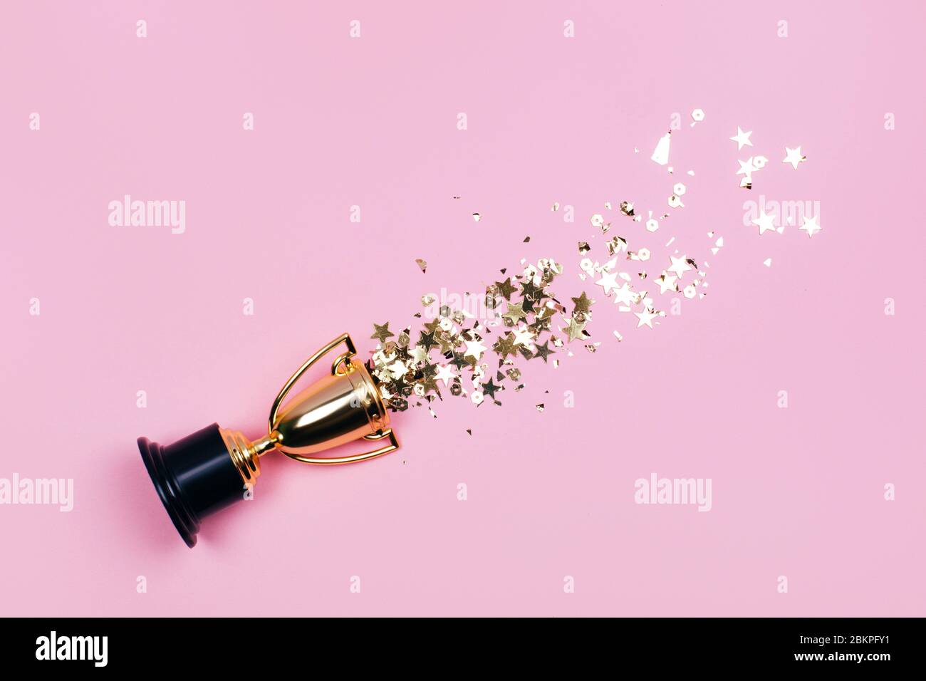 One winners cup with golden sparkles on a pastel background. Banner ...