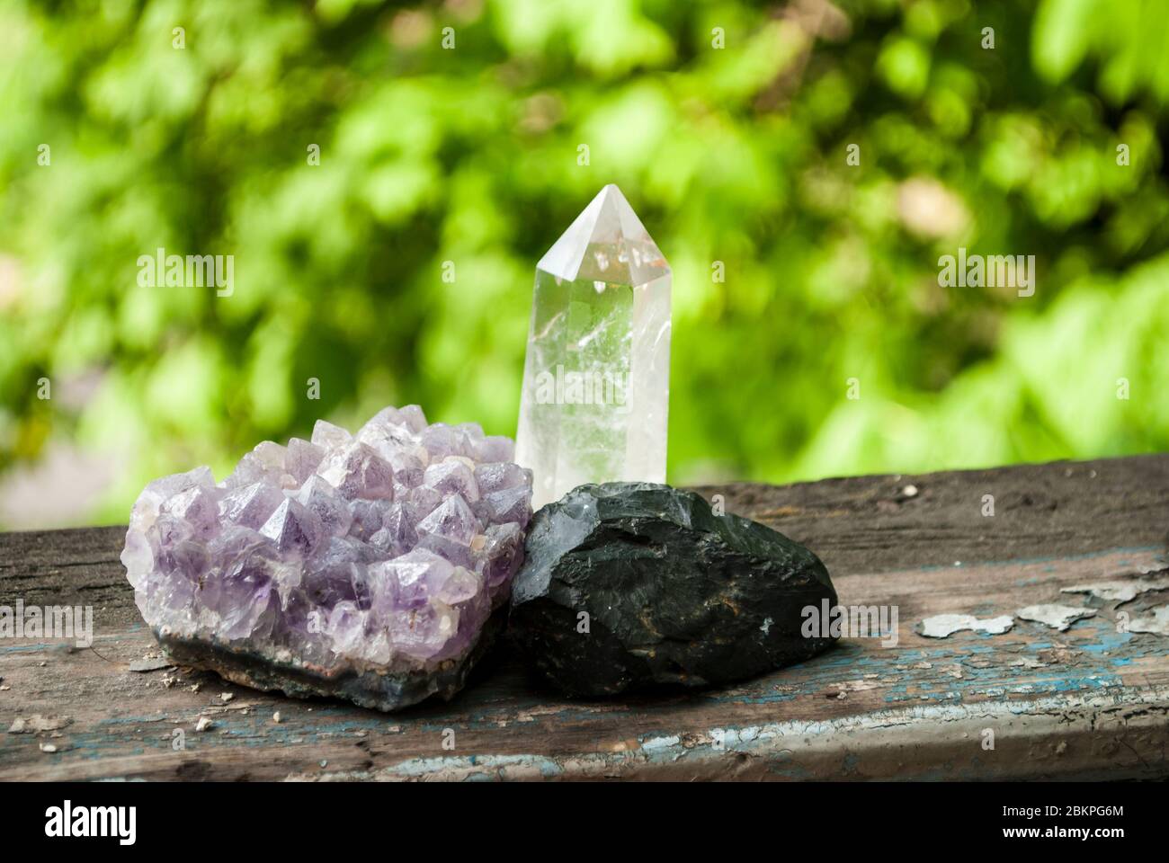 Coal, amethyst, quartz. Natural crystal without processing on a green ...