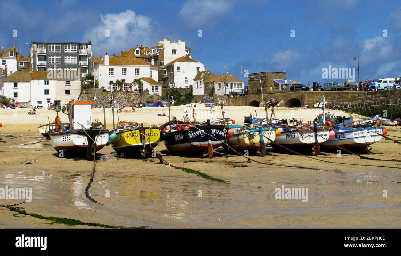 Fishing boats moored in the picturesque Cornish village of St Ives, UK ...