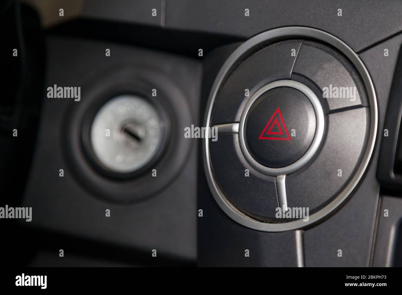 Close-up on emergency round button with red triangle icon on the car ...