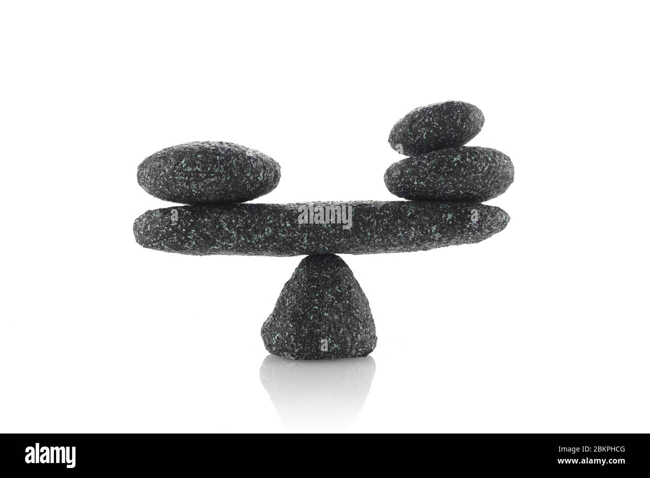 Balancing black stones isolated on white background Stock Photo - Alamy