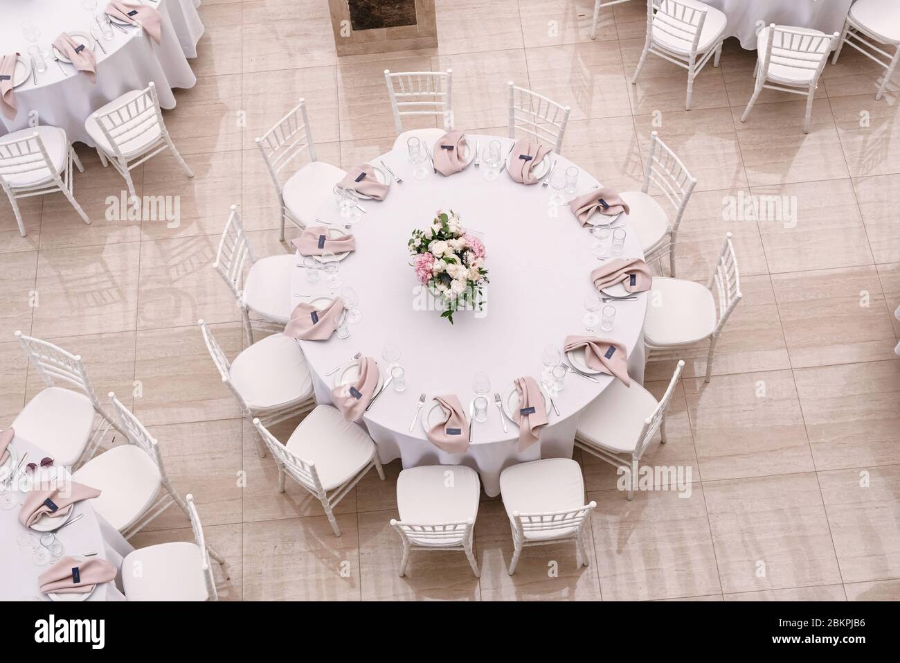 The luxurious round table for the wedding lunch is decorated with ...
