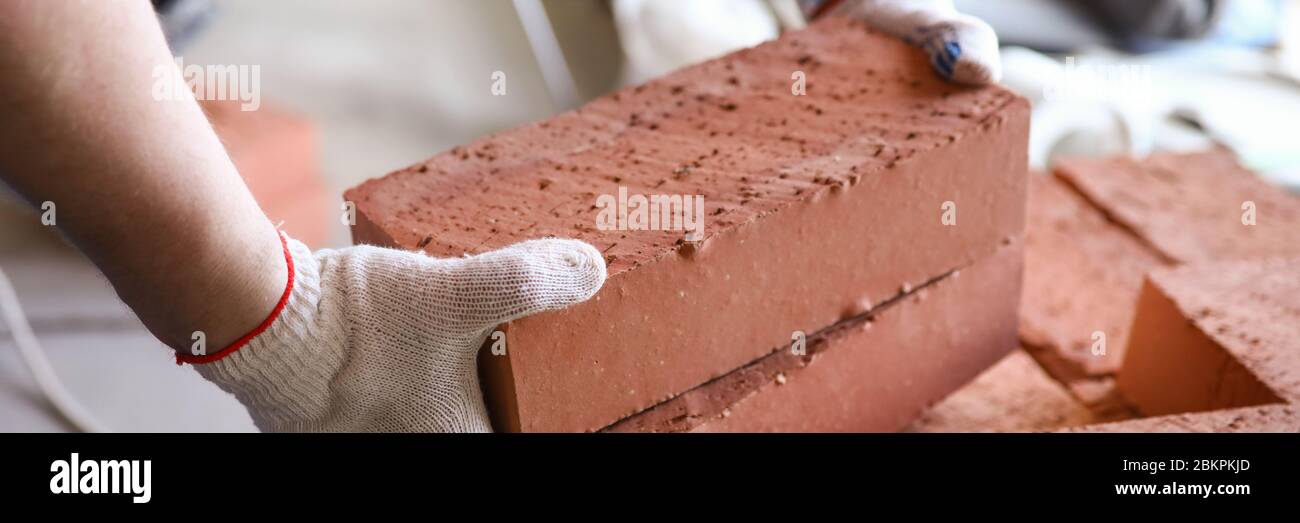 Worker man carry blocks Stock Photo - Alamy