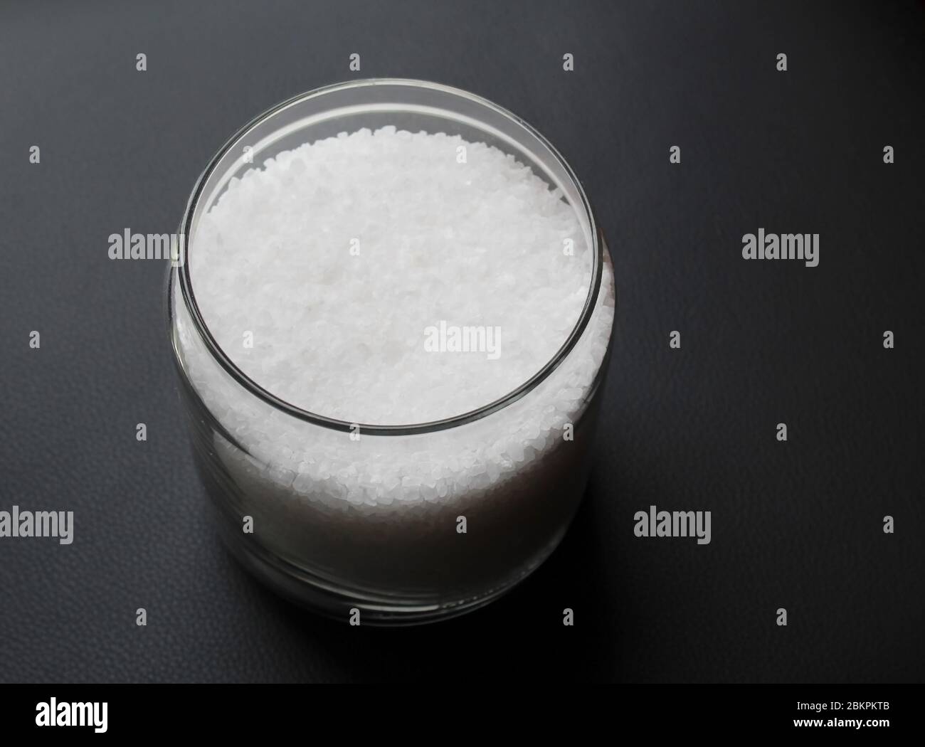 Coarse salt grains in a transparent glass jar Stock Photo - Alamy