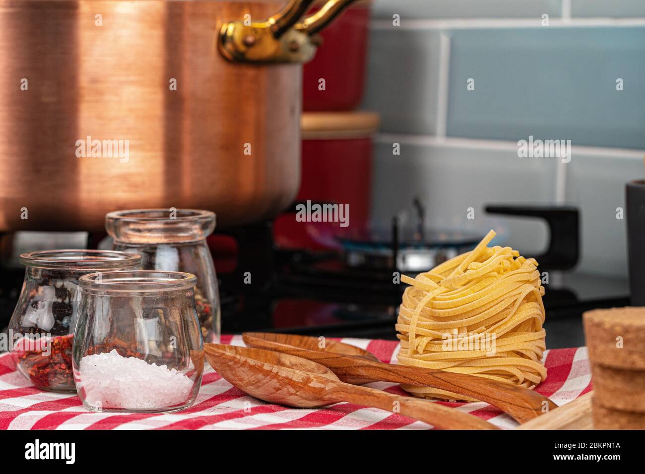 Dry spaghetti on a kitchen counter with cooking utensils Stock Photo ...