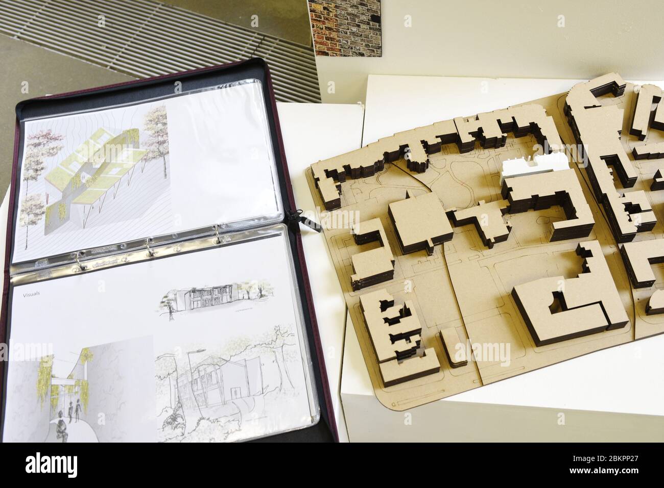 An architectural model with drawings in a portfolio. An trainee ...