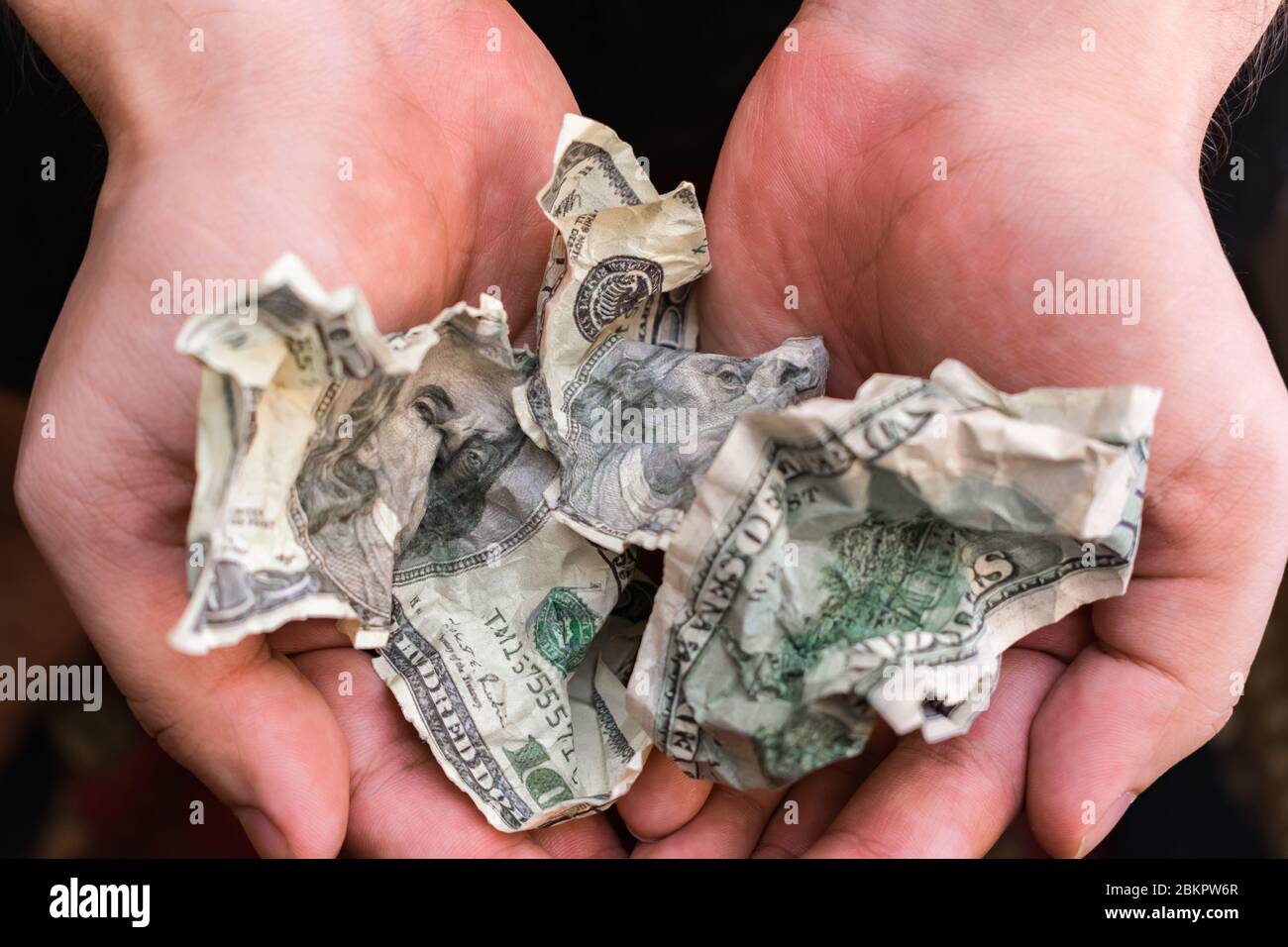 Recycling fake banknotes. Counterfeit banknotes wrinkled in hands Stock ...