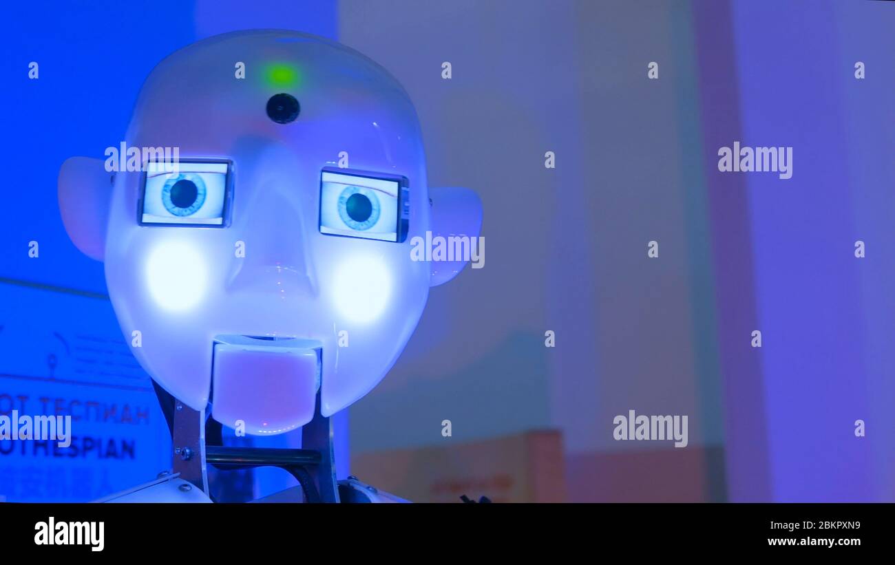 Portrait of funny humanoid robot at technology exhibition. Close up ...