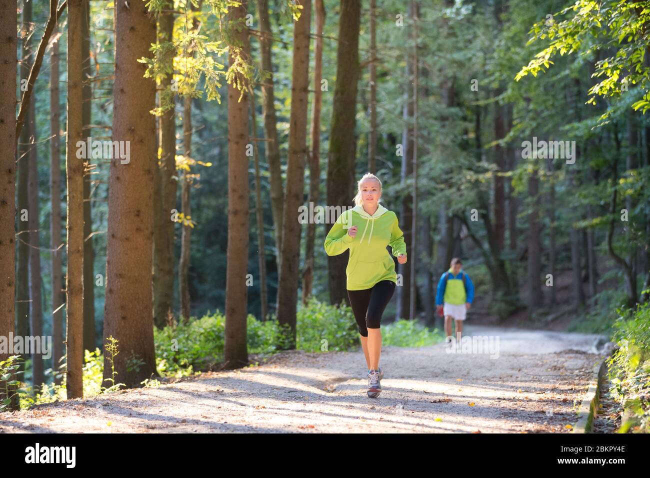 Pretty young girl runner in the forest Stock Photo - Alamy